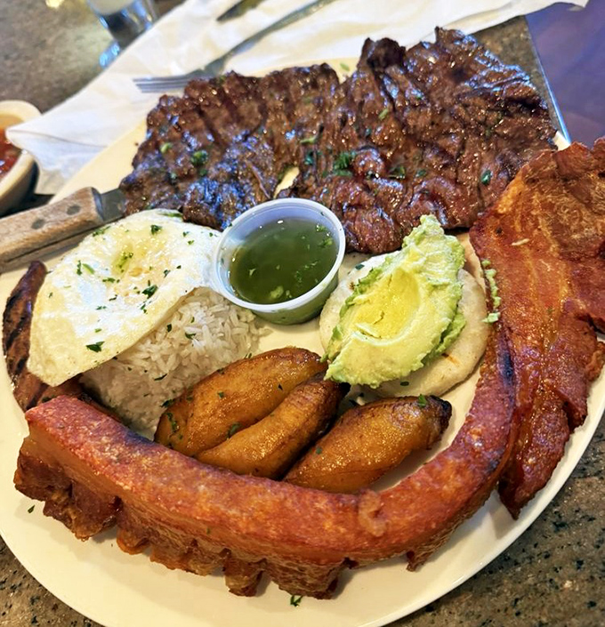 Colombia's national treasure arrives tableside &ndash; a protein-packed powerhouse featuring steak, chicharr&oacute;n, egg, and avocado that demands both camera and appetite attention.