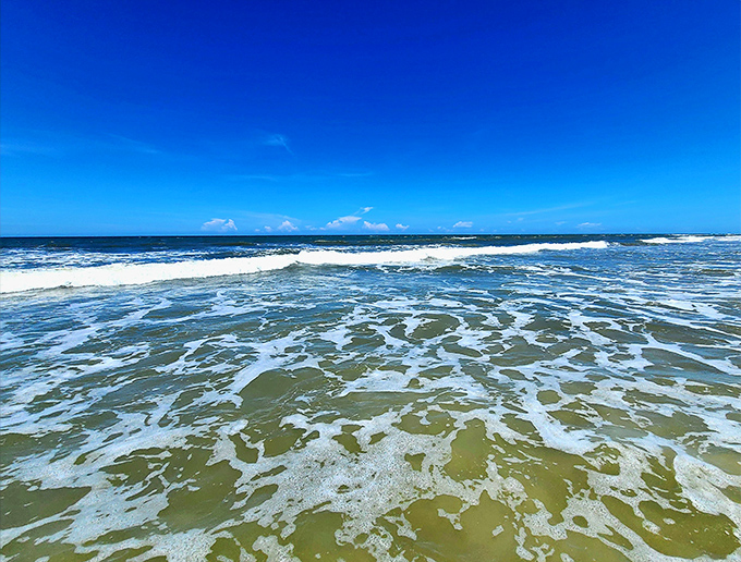 Ocean waves perform their endless dance along the shoreline, a hypnotic rhythm that's been playing since before humans arrived to appreciate it.