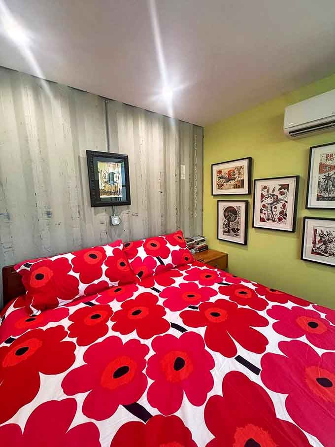 Bold floral patterns explode across the bedding, creating a tropical garden oasis against lime green walls &ndash; subtlety checked out of this room long ago.