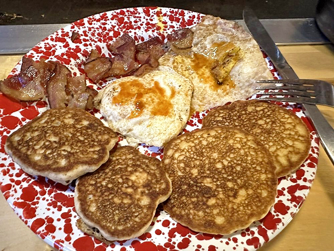 A classic breakfast spread featuring golden pancakes, crispy bacon, and eggs – the holy trinity of morning deliciousness.