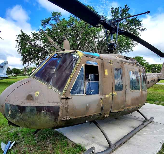 The Huey helicopter sits ready for inspection, its Vietnam service written in every weathered panel and worn component.