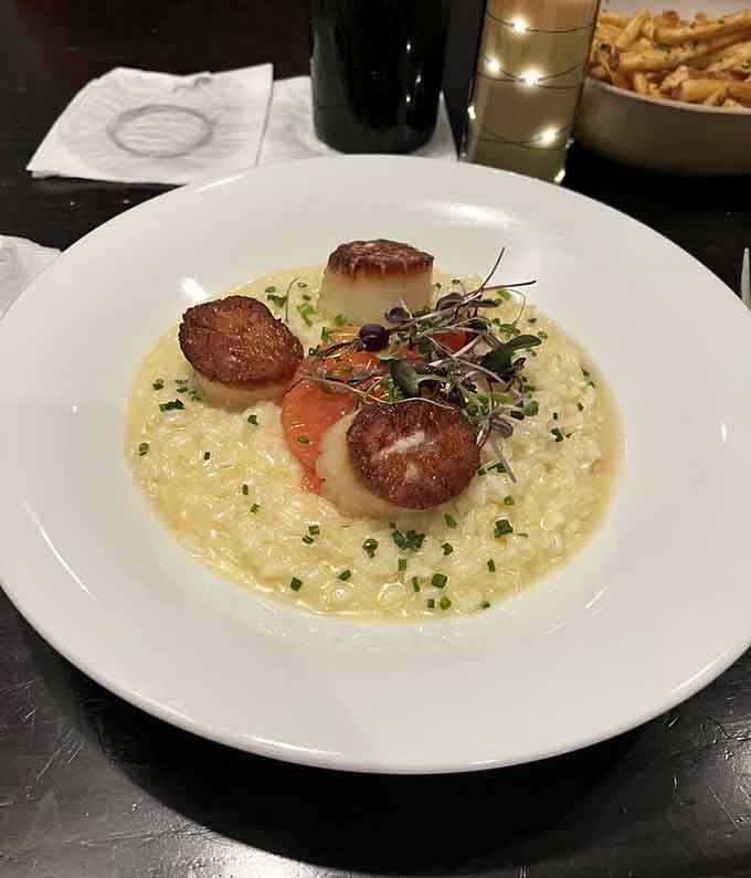 Perfectly seared scallops nestle into creamy risotto like they were always meant to be together, and honestly, they were.