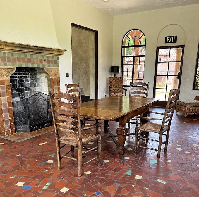 Gather 'round this rustic dining table where citrus magnates once clinked glasses, beneath the colorful tiled fireplace.