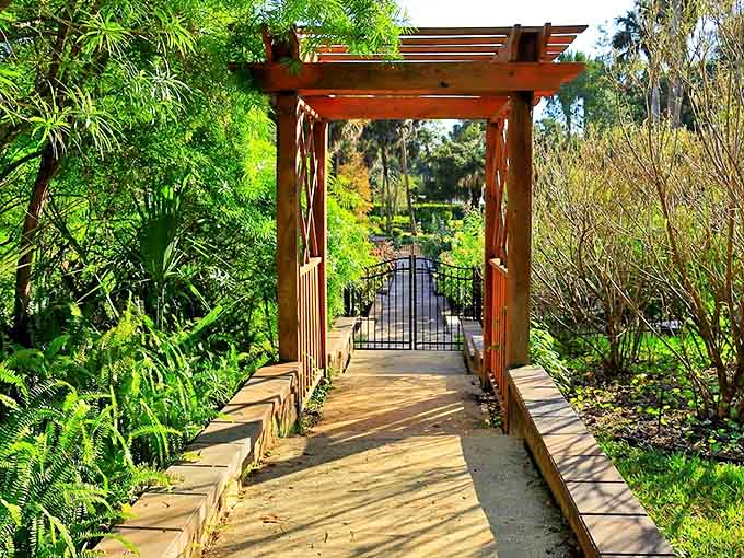 Gateway to serenity: This wooden pergola marks the entrance to gardens that feel worlds away from Florida's typical tourist haunts.