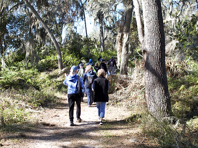 Nature enthusiasts explore the park's winding trails, where every turn offers a new discovery and conversation flows as easily as the nearby water.