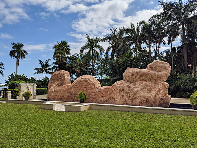 Undulating brick forms create a horizontal landscape that seems to ripple like frozen waves across the manicured grounds.