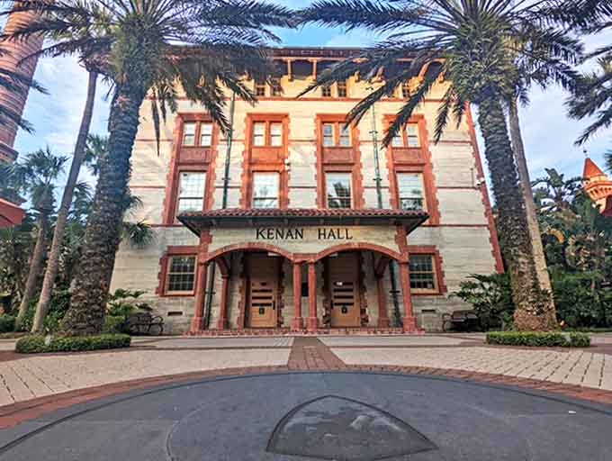 Kenan Hall welcomes visitors with palm-flanked elegance that makes dorm move-in day feel like checking into a five-star resort.