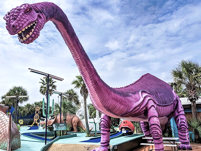 The purple dinosaur looms like a prehistoric scorekeeper, its vibrant hue a middle finger to natural history and subdued color schemes.