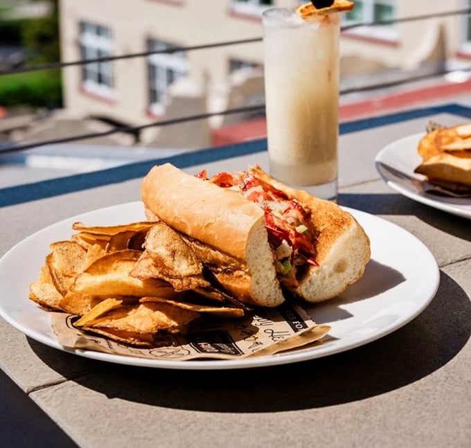 The lobster roll that launched a thousand return visits, nestled beside house-made chips like the perfect Florida power couple.