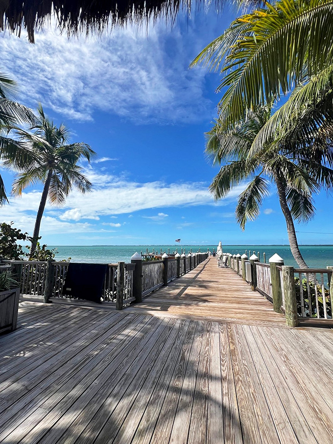 The wooden pier stretches toward the horizon like an invitation to paradise, framed by Florida's impossibly blue skies.