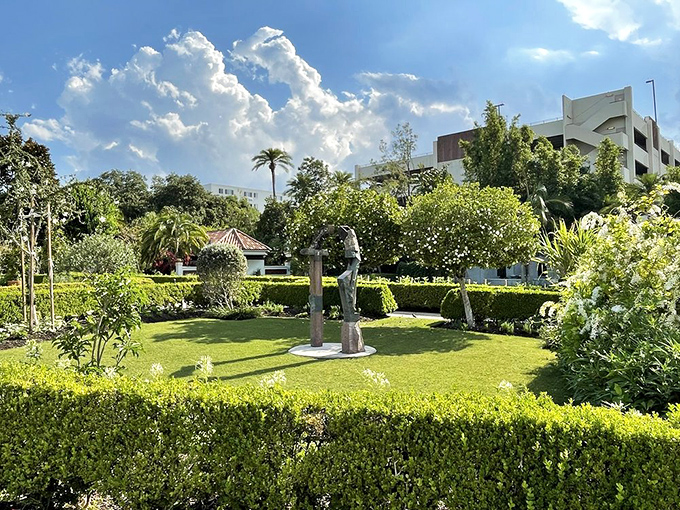 Nature's perfect composition &ndash; vibrant flowers, structured hedges, and towering palms create living architecture against a brilliant blue sky.
