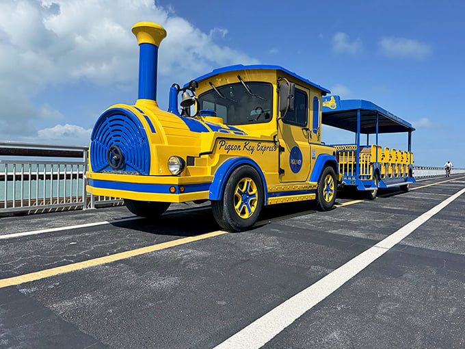 Sunshine yellow meets ocean blue on this whimsical locomotive, looking like a storybook illustration come to life against the Florida sky.