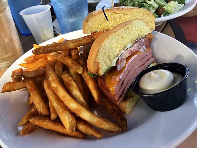 Behold the fried bologna sandwich in all its crispy-edged glory, flanked by golden fries that could make a nutritionist weep with joy.