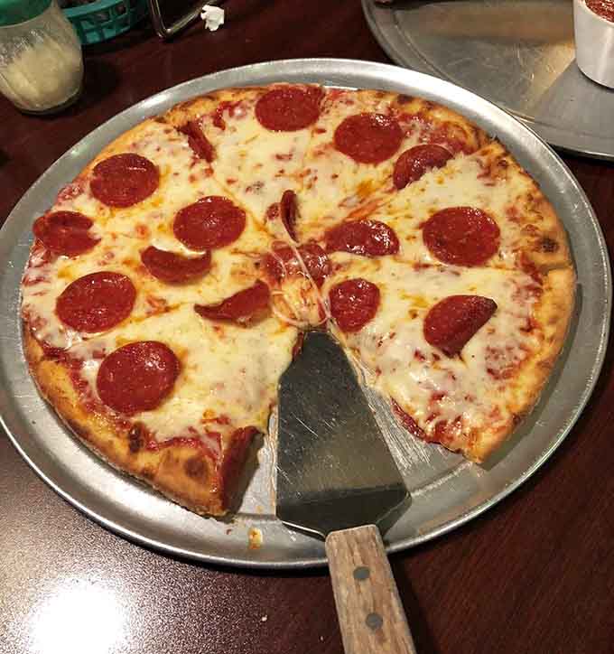 Pepperoni pizza at Pino's features those perfectly cupped slices that create little pools of spicy, savory goodness.