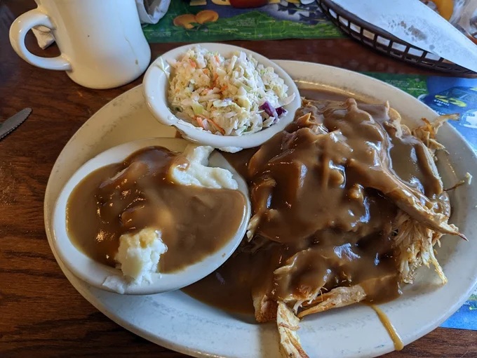 Tender roast smothered in rich gravy alongside creamy mashed potatoes and tangy coleslaw &ndash; a plate that whispers "take a nap after this."