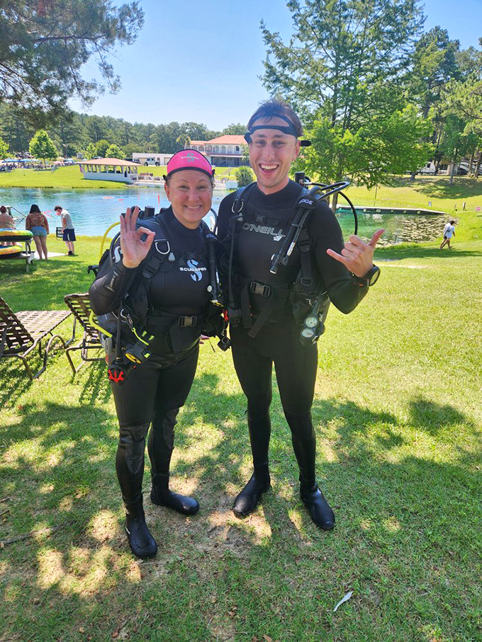 Scuba enthusiasts in their natural habitat, giving the universal "everything's awesome" hand signal that divers have perfected worldwide.