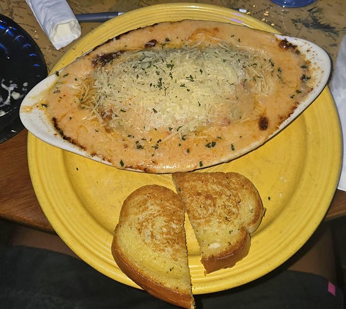 Seafood lasagna perfection: Bubbling cheese crowns this legendary dish, where tender pasta cradles fresh seafood in a sauce that might make you weep with joy.