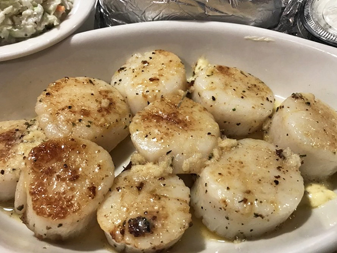 These perfectly seared scallops might make you forget about any ghostly presence – golden-brown exteriors giving way to buttery, tender centers.