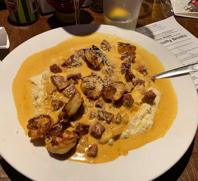 Creamy grits cradle perfectly sautéed shrimp in a velvety sauce – a dish so good it might make you consider relocating to be closer to it.