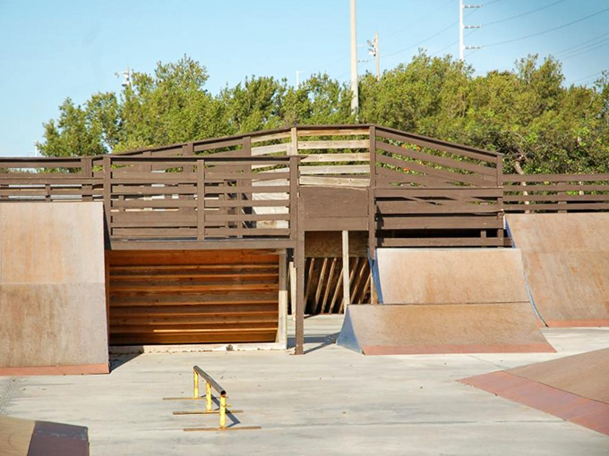 Skate Park Ramps Concrete waves await daring souls, where gravity becomes both nemesis and friend in this wooden-flanked skater's paradise.