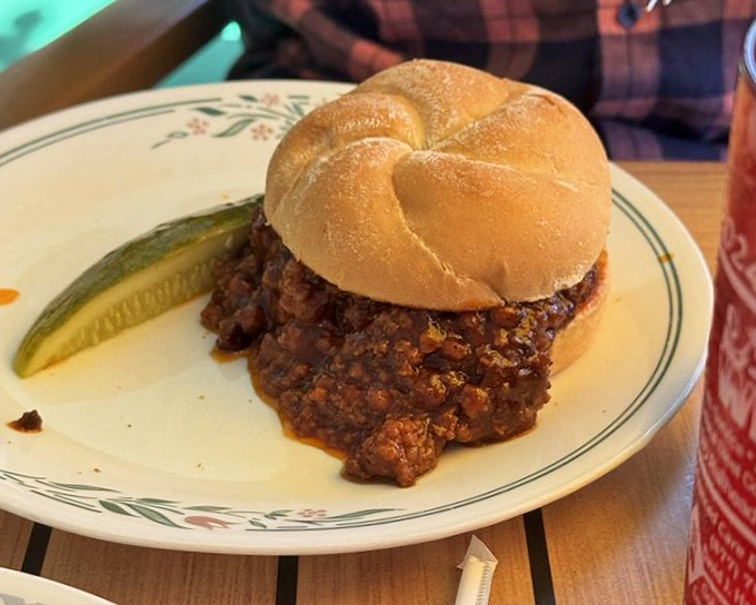 Not your cafeteria Sloppy Joe! This hearty sandwich demands both napkins and respect, with a pickle standing guard.