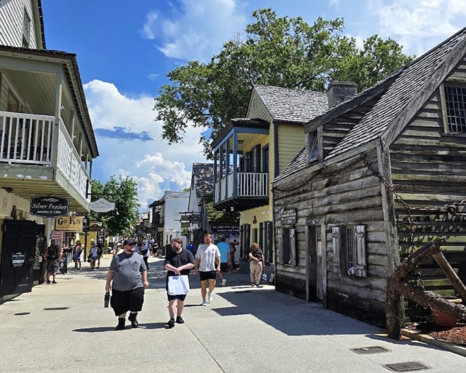 St. George Street bustles with modern visitors, creating a striking contrast against the ancient schoolhouse that's witnessed centuries of changing fashions.