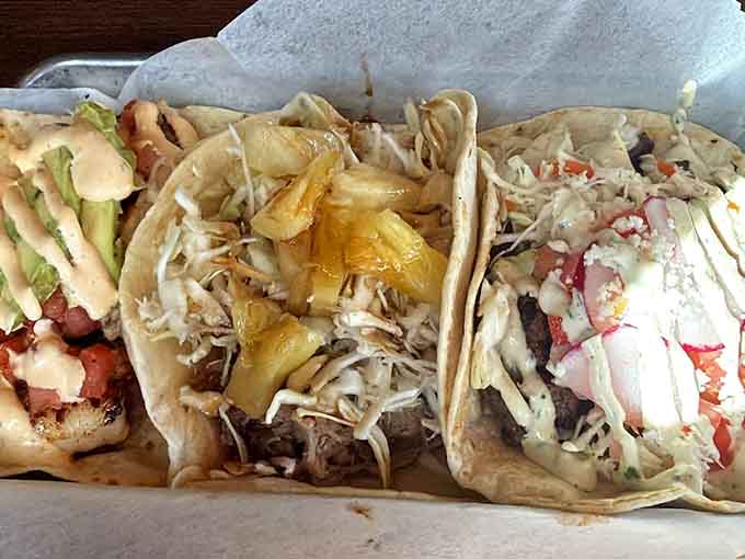 Three tacos walk into a basket, each one a different flavor adventure, proving variety isn't just the spice of life but the whole spice rack.