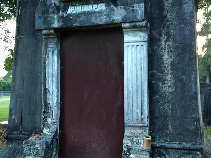 The simple wooden door belies the elaborate exterior, a humble barrier between two worlds that sparks more questions than it answers.