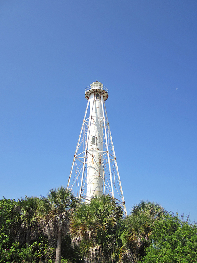 The historic Gasparilla Island Lighthouse stands tall against an impossibly blue sky, still guiding mariners just as it has since 1890.
