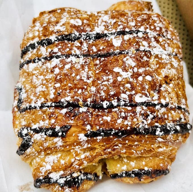 Behold the chocolate croissant in all its flaky, buttery, chocolate-ribboned glory, ready to make your morning infinitely better.