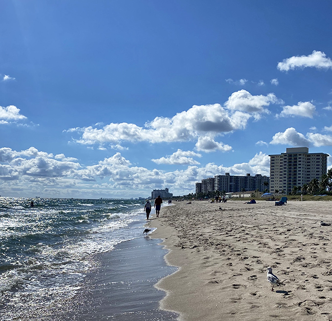 Where the horizon meets possibility – strollers enjoy Lauderdale-by-the-Sea's pristine shoreline under a perfect Florida sky.