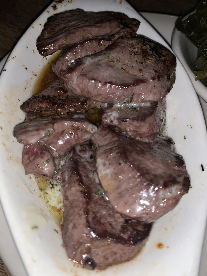 Perfectly cooked venison steak, the restaurant's signature dish, showcases the kitchen's mastery of wild game preparation.