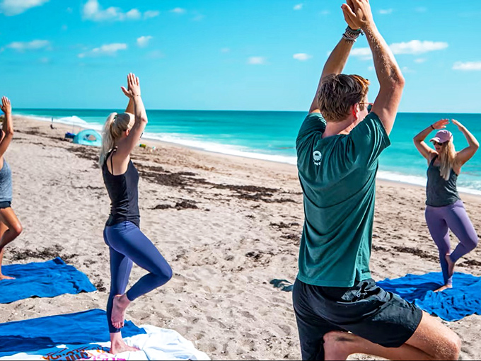 Beach yoga enthusiasts find their zen where ocean meets sky, proving the best studio has no walls and comes with complimentary sea breezes.