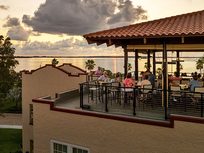 Guests enjoy sunset cocktails on the rooftop terrace, where Gulf views compete with conversation for attention.