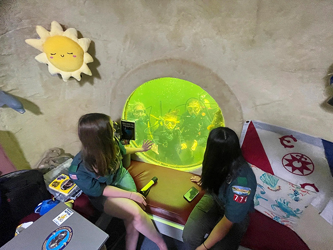 Young guests marvel at the underwater world through one of the lodge's signature portholes, creating memories that will last a lifetime.