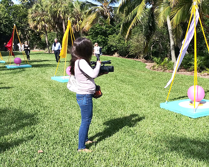 Visitors capture memories in The Kampong's open spaces, where colorful installations add whimsy to the natural splendor.