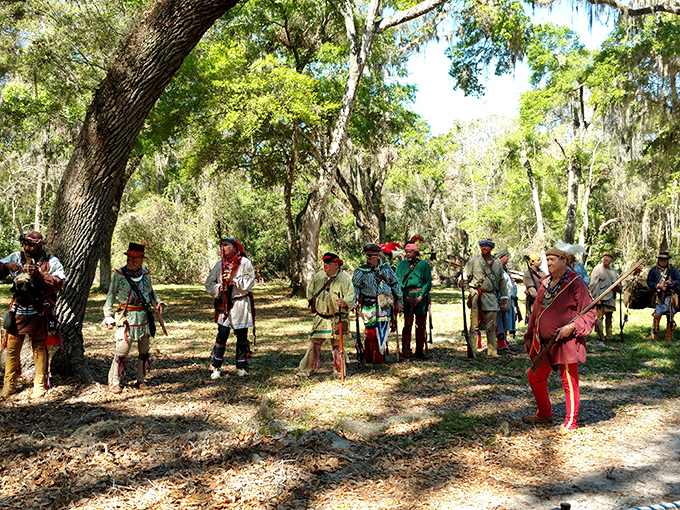 Stepping back in time with these historical reenactors! Sun-drenched woods and vibrant period attire make history spring to life.