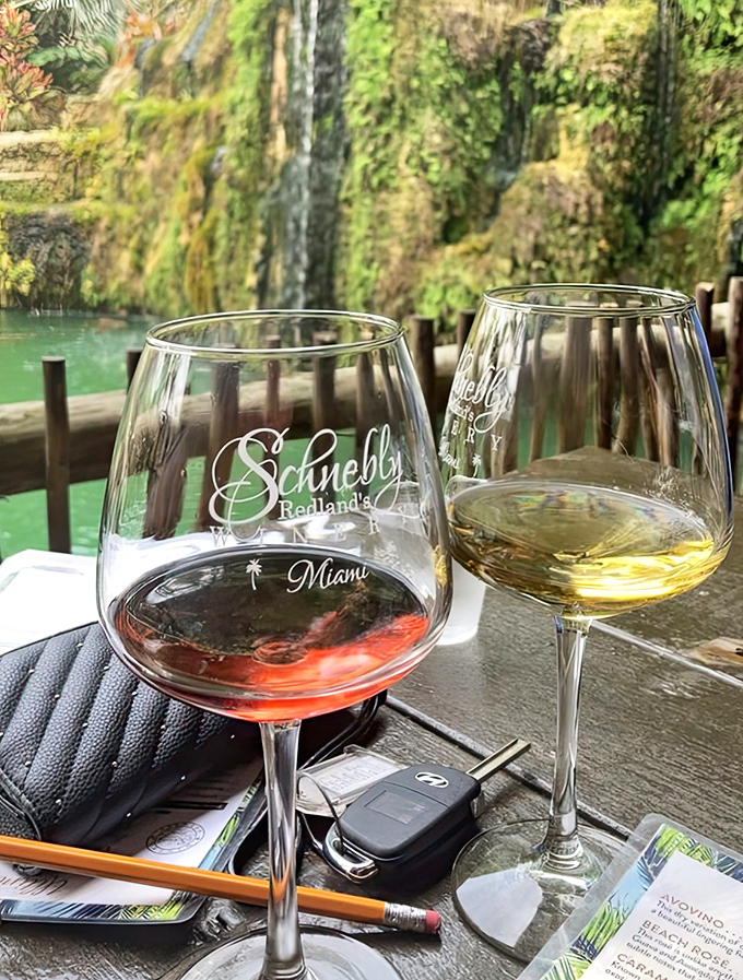 Nature's perfect pairing: Sipping award-winning tropical wines beside the gentle cascade of Schnebly's signature waterfall.
