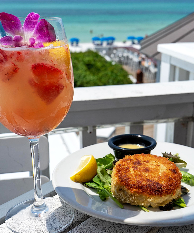 Crab cake & cocktail: The dynamic duo of vacation happiness &ndash; golden crab perfection meets a fruit-garnished cocktail with that million-dollar view behind.