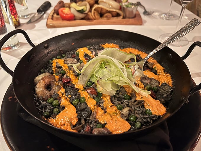 This isn't just dinner &ndash; it's an edible expedition. The black paella arrives like a mysterious sea treasure, its inky depths hiding delicious secrets.