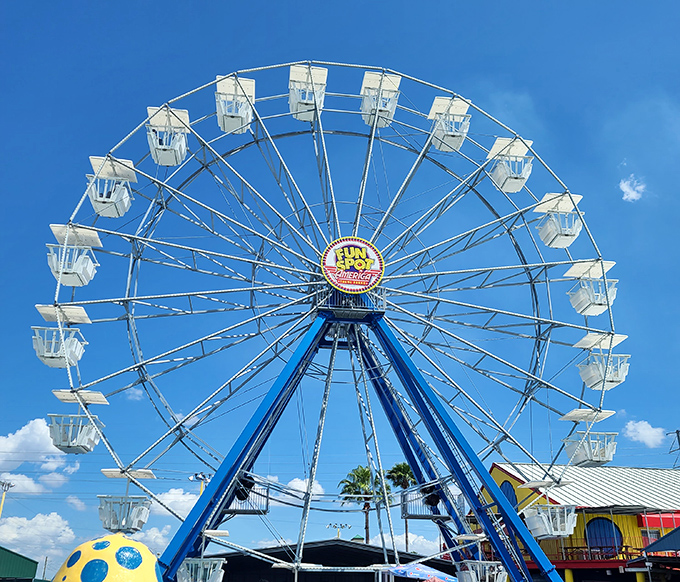 The Ferris wheel stands as a peaceful sentinel amid the excitement below. Some relationships have lasted shorter than the perfect moment at the top.