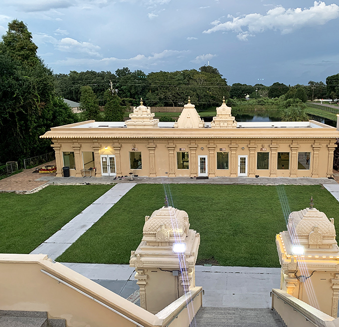 From the temple stairs, visitors gain a panoramic view of the complex, where traditional Dravidian architecture creates a stunning contrast with Florida's palm trees.