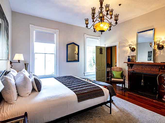 Crisp white linens and period furnishings create a sanctuary of comfort, though some guests swear they've felt the mattress depress when no one was there.