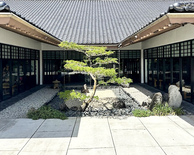 Zen simplicity meets architectural poetry in this courtyard where even the rocks seem to be meditating.