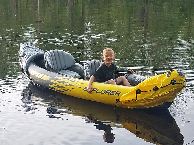 Pure joy afloat! This young explorer discovers the freedom of paddling his own vessel through nature's water park.