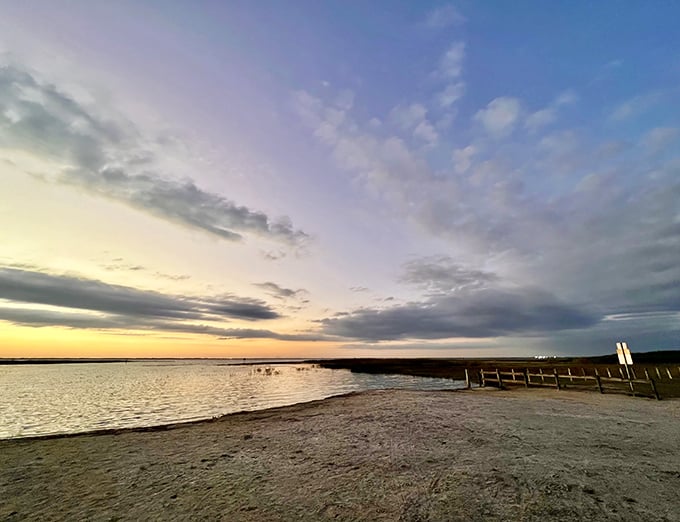 Sunset transforms the shoreline into a golden retreat, where the day's final light writes poetry across sand and shallow waters.