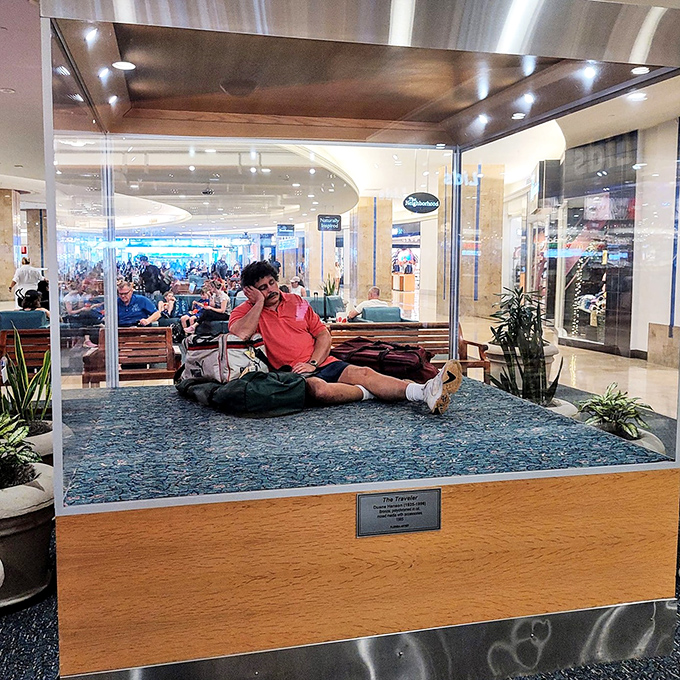 The sleeping man sculpture captures that universal moment of travel exhaustion we've all experienced &ndash; head heavy, dreams of hotel beds.
