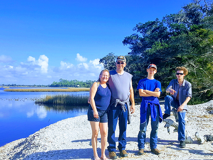 Adventure seekers pause along Shired Island's pristine shoreline, creating memories that will outlast any souvenir shop trinket.