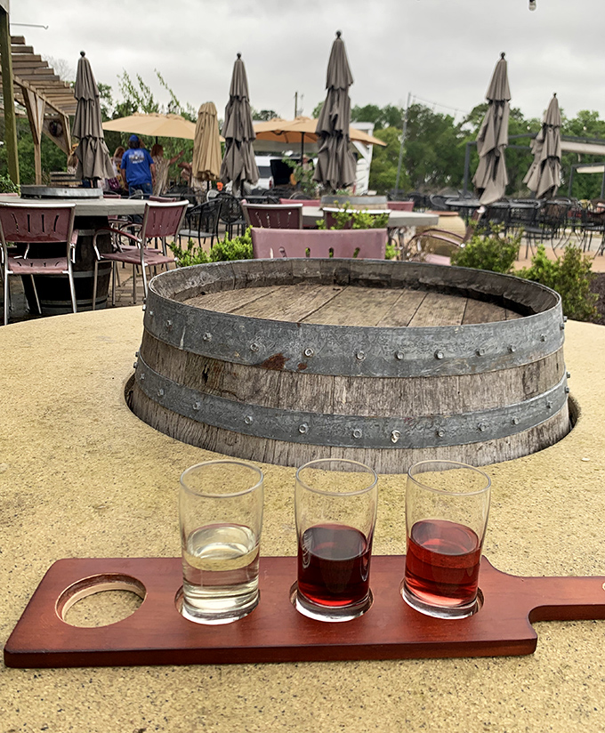 A flight of local wines awaits sampling, arranged on handcrafted wooden paddles that showcase the winery's attention to detail.