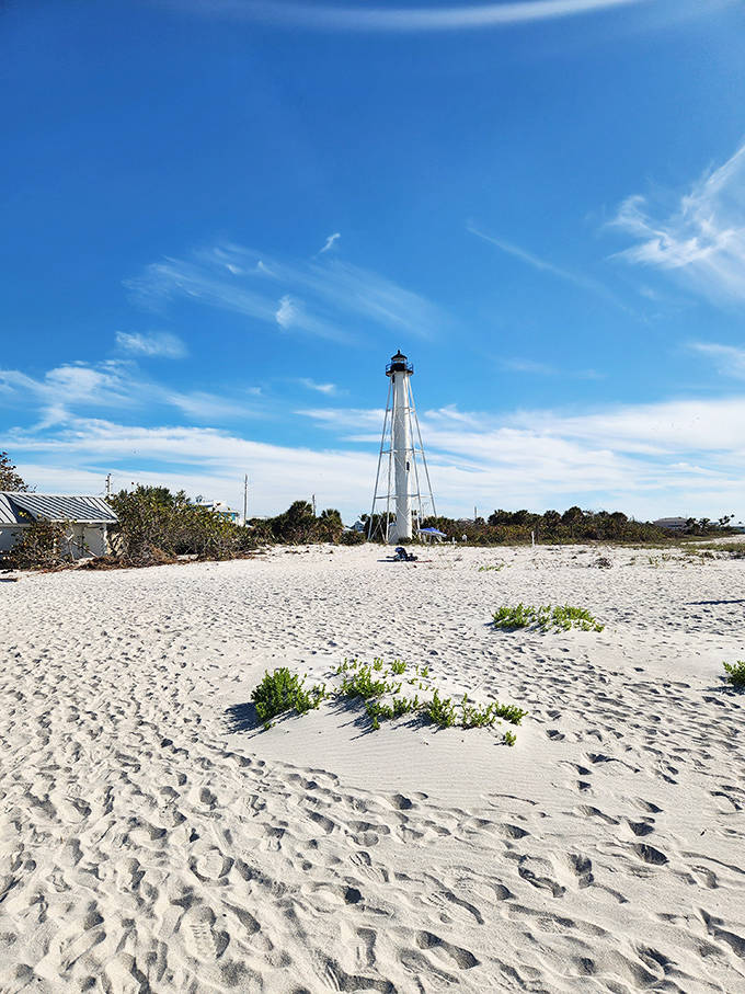 Port Boca Grande Lighthouse stands as a whitewashed sentinel against the brilliant blue sky, guarding secrets of shipwrecks and sailors past.